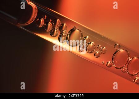 A dropper with sunscreen body serum in the orange sunset light Stock ...