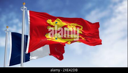 Flags of Normandy and France waving in the wind on a clear day ...