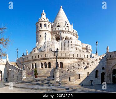 Historic white castle tower with a conical roof surrounded by green ...