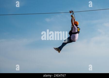 Zipline riders, Person on blue sky background, extreme leisure Stock ...