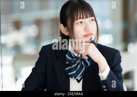 Schoolgirls in uniform studying Stock Photo - Alamy