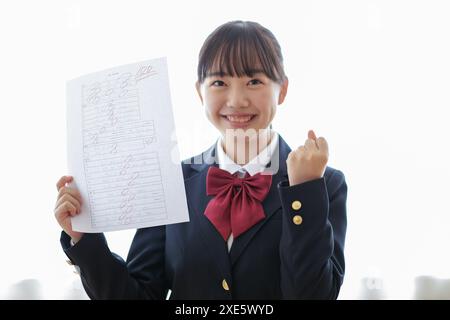 Girl holding test with perfect score Stock Photo - Alamy