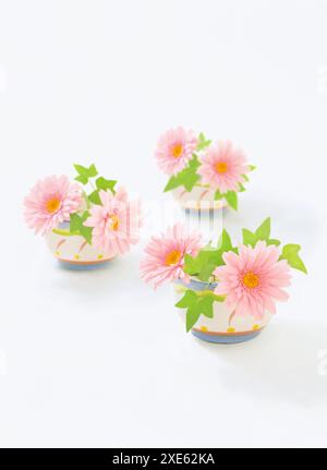 Gerbera flowers bouquet and coffee cup in front of stone wall. With ...