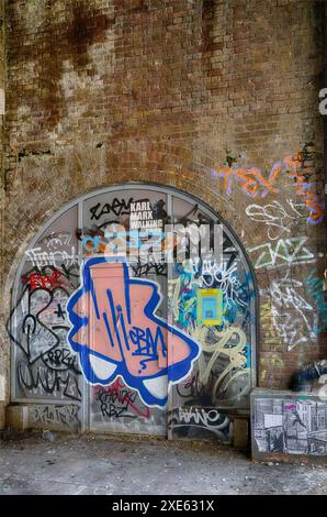 Graffiti on door on old railways arches close ot Waterloo Station ...