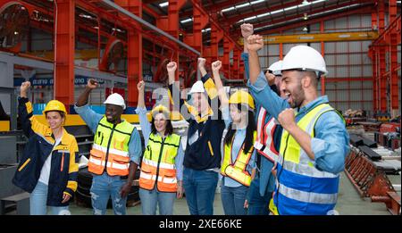 Group of factory workers in hardhats with joint hands together for ...