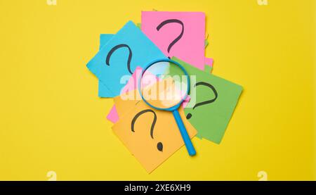 Drawn question marks on stickers and a magnifying glass, yellow ...