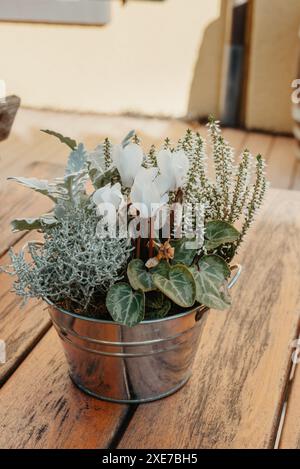 flowers decorative bucket wooden table. Flower composition. Bouquet of ...