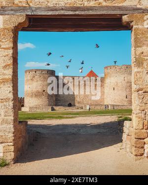 Stone wall with gateway and towers over rocky hill at the Linhares da ...
