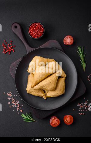Delicious pancakes triangular shape with meat, salt and spices Stock ...