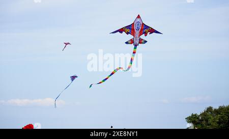 Rocket shaped kite, soaring through the blue sky with white clouds in ...