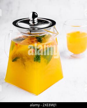 orange and mint tea served in cup and teapot Stock Photo - Alamy
