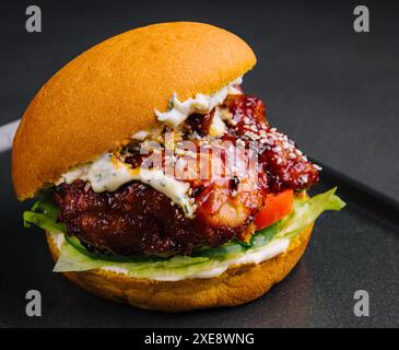Craft burger is cooking on black background. Consist: sauce sals Stock ...