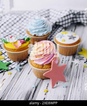 Multiple colorful nicely decorated muffins on a white background, top ...