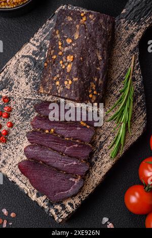Delicious dry-cured beef basturma with rosemary and spices on white ...