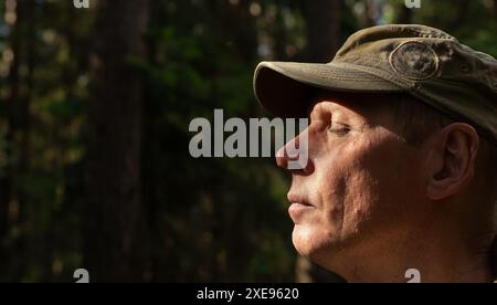 Mature man enjoying nature, breathing, inhaling fresh air in summer ...