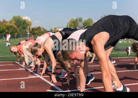 Group of young athlete runnner are training at the stadium outdoors ...
