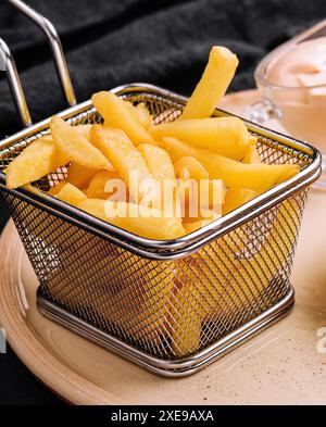 French fries in a metal basket mesh Stock Photo - Alamy