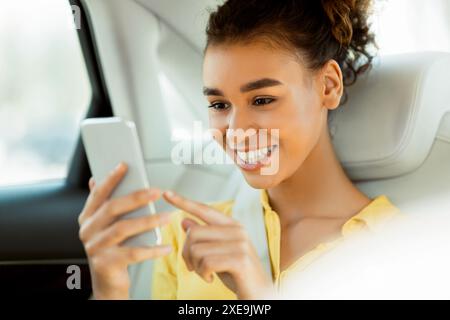 Contemporary black passenger car navigating urban street traffic with ...