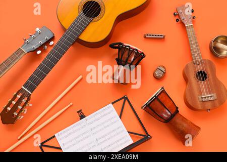 Different musical instruments and music notes on orange background ...