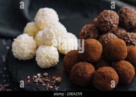 three types of chocolate balls on stone board Stock Photo - Alamy
