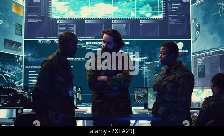 Brigadier general and his staff studying radar data on a holographic ...
