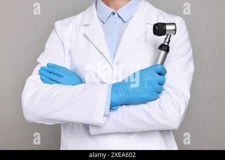 Dermatologist with dermatoscope on grey background, closeup Stock Photo ...