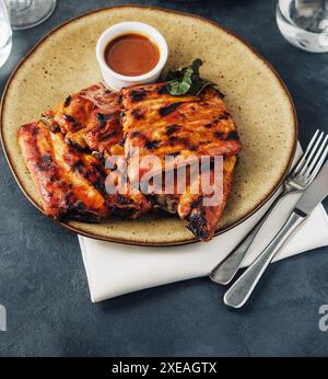 Grilled pork ribs on a fork. Grilled meat sprinkled with rosemary on a ...