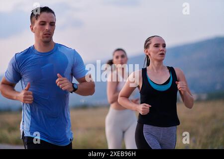 A diverse group of runners trains together at sunset Stock Photo - Alamy