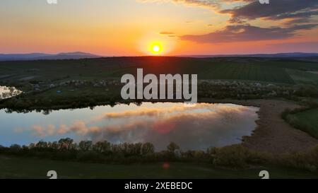 Sunset wavy hills with fields and pond Stock Photo - Alamy