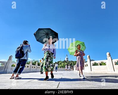 Tourists visit Beihai Park amid hot weather in Beijing, China, 16 June ...