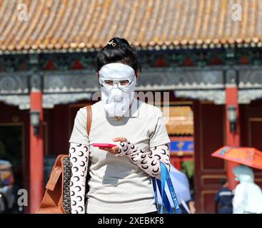 Tourists visit the Palace Museum amid hot weather in Beijing, China, 25 ...