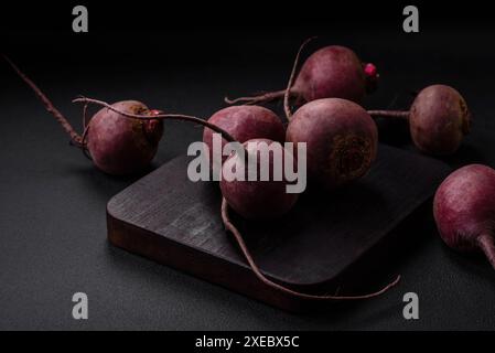 Fresh raw beetroot in the form of tubers on a textured concrete ...