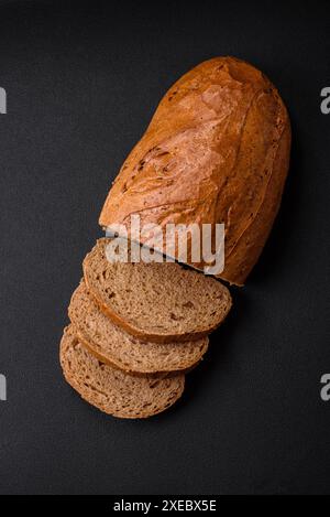 Delicious fresh crispy loaf of white bread with grains and seeds on a ...