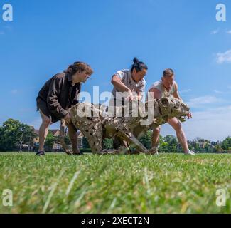 London, UK. 27th June 2025. Puppeteers take a life-size giraffe puppet ...