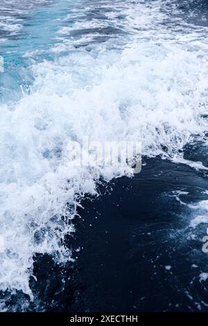 Sea water churned up into foam by the engine of a small boat Stock ...