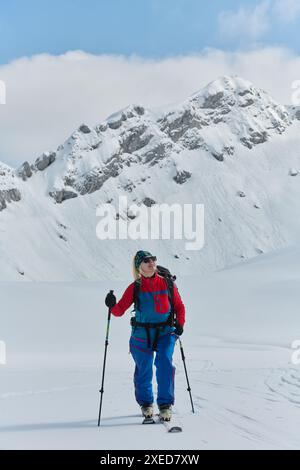 A Female Mountaineer Ascends the Alps with Backcountry Gear Stock Photo ...