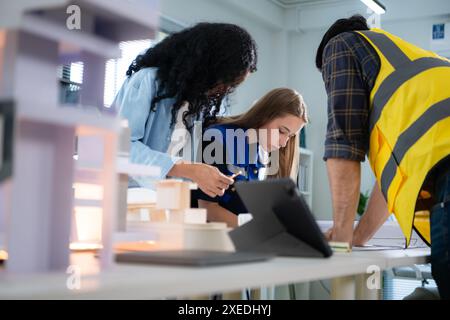 Architects, building engineers or designers with tablet talking ...