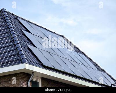 Newly build houses with solar panels attached on the roof against a ...
