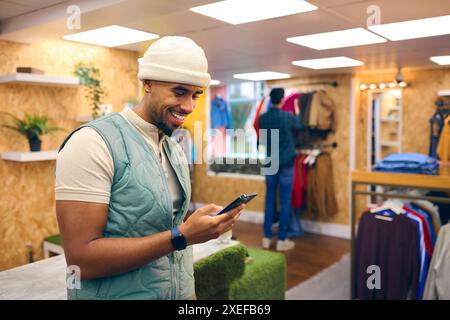 man looking on phone with pop-eyed view. coffee to go in hands Stock ...