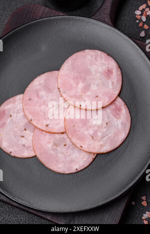 Delicious fresh ham cut into round slices with salt, spices and herbs ...