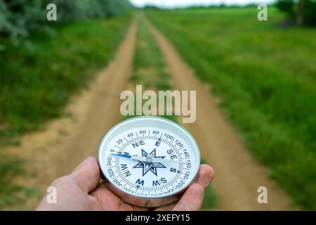 Hiking. Compass direction on the plain, country road Stock Photo - Alamy
