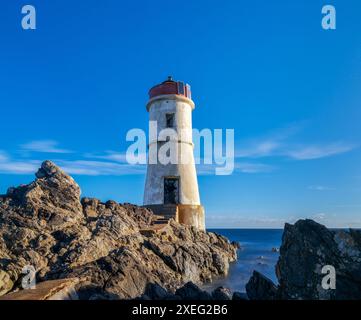 A panorama landscape view of the old Capo Ferro Lighthouse in Sardinia ...