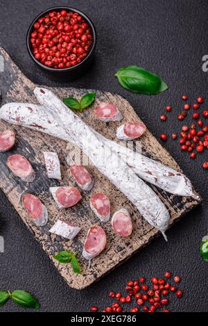 Salami sausage fuet on white textured background with copy space Stock ...