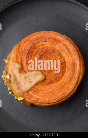 Round sweet New York roll croissant with raspberry cream filling on a ...