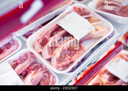 Packaged mutton meat laid out on display shelves of butcher store Stock ...