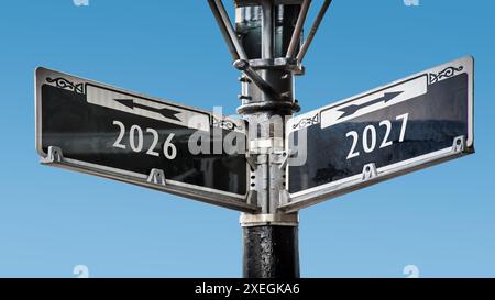 Signposts the direct way to 2026 versus 2027 Stock Photo - Alamy