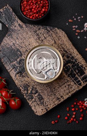 Round metal can with canned meat or fish with a key to open it on a ...