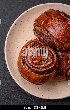 cinnamon buns on a dark background. coffee, sugar, berries Stock Photo ...