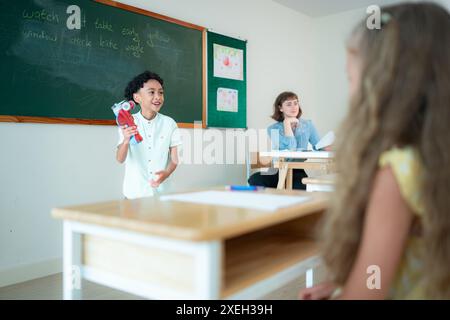 Children with classroom presentation activities in front of the ...