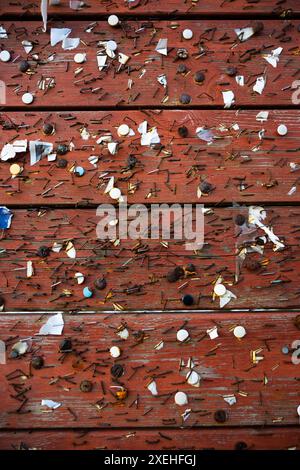 Staples and pins on a red notice board Stock Photo - Alamy